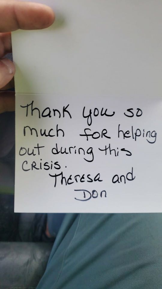 Thank you signs decorate trash cans for worker helping others run ...