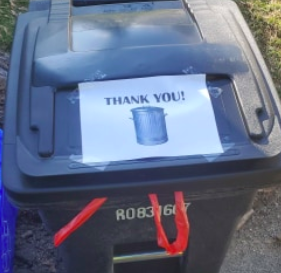 Thank you signs decorate trash cans for worker helping others run ...