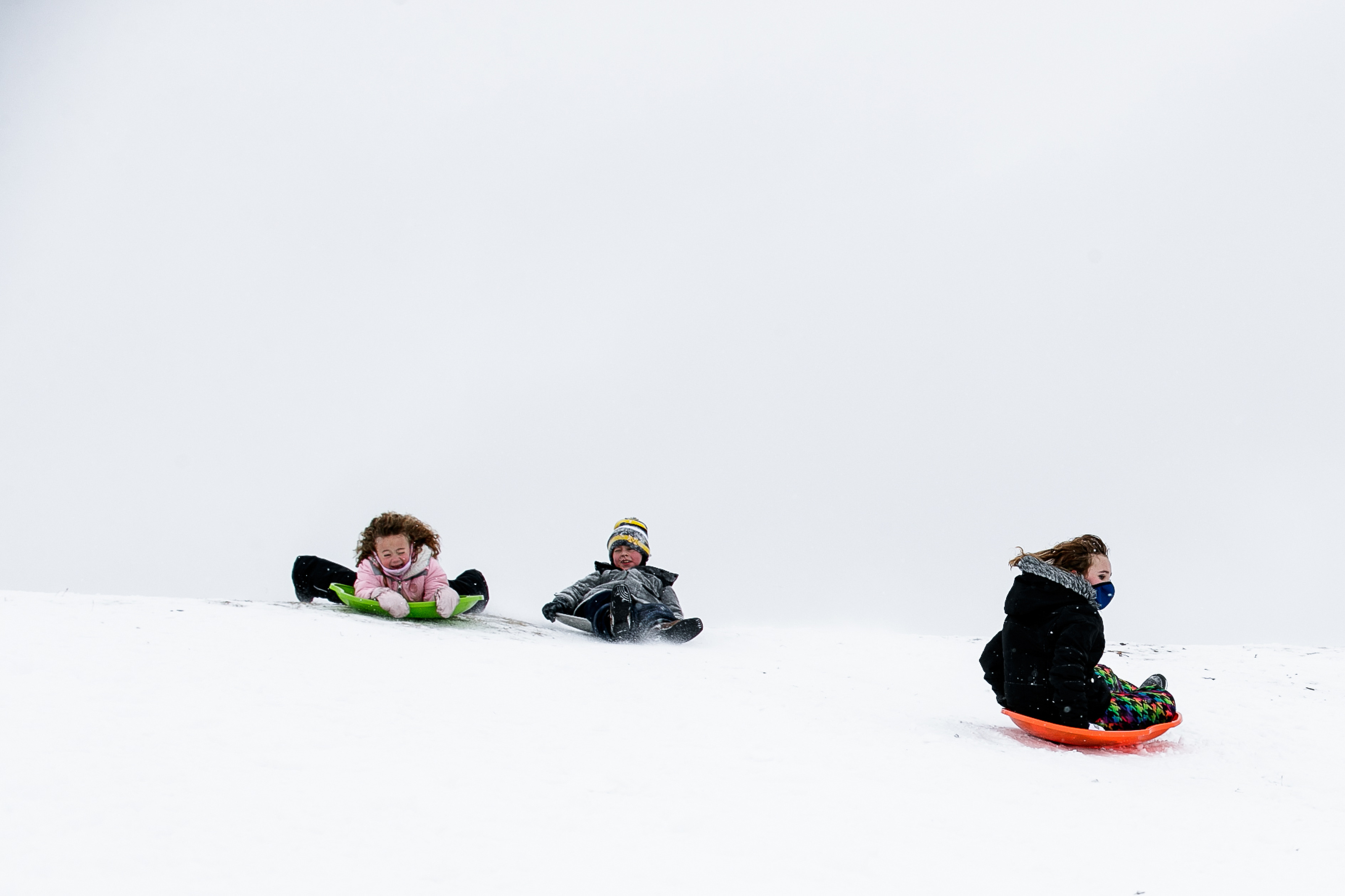 Families enjoy the snow, sledding hill at Flint Southwestern Classical ...