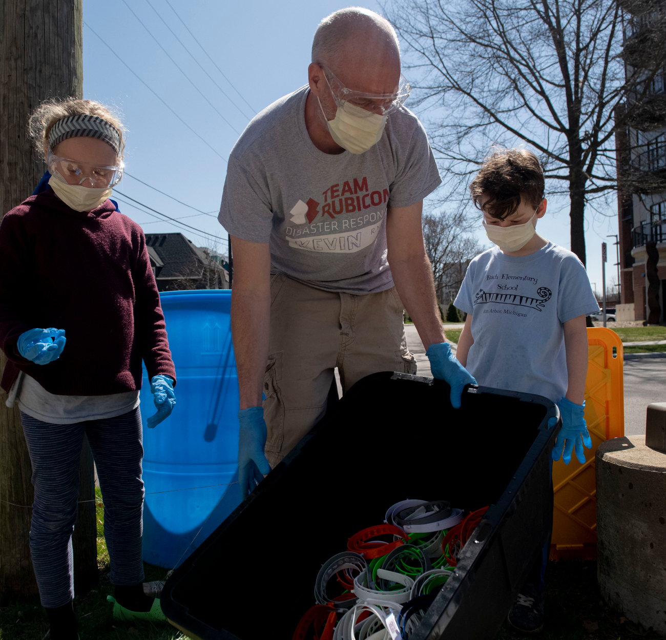 Kevin Leeser and his children prepare shields for healthcare workers ...