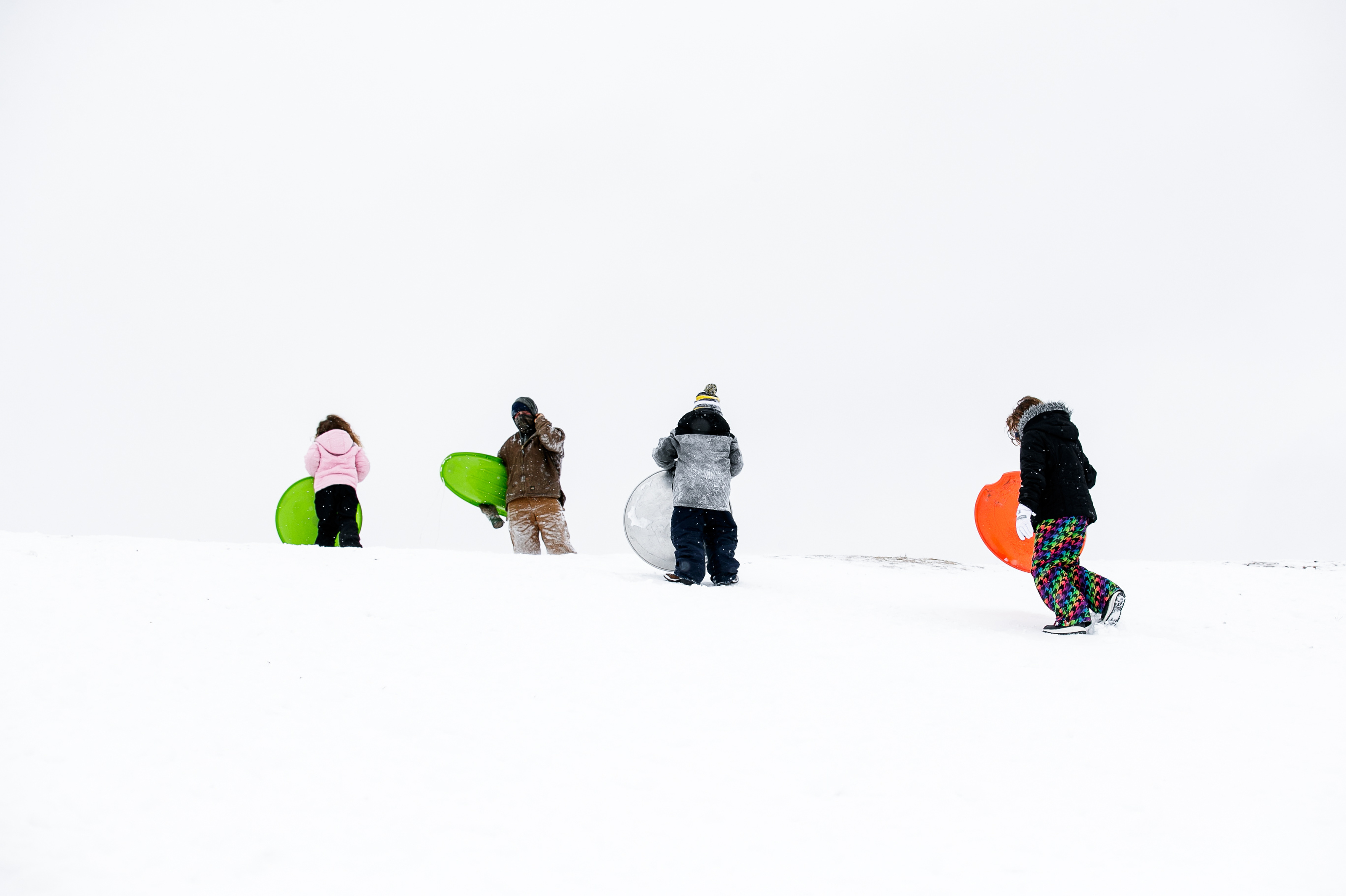 Families enjoy the snow, sledding hill at Flint Southwestern Classical ...
