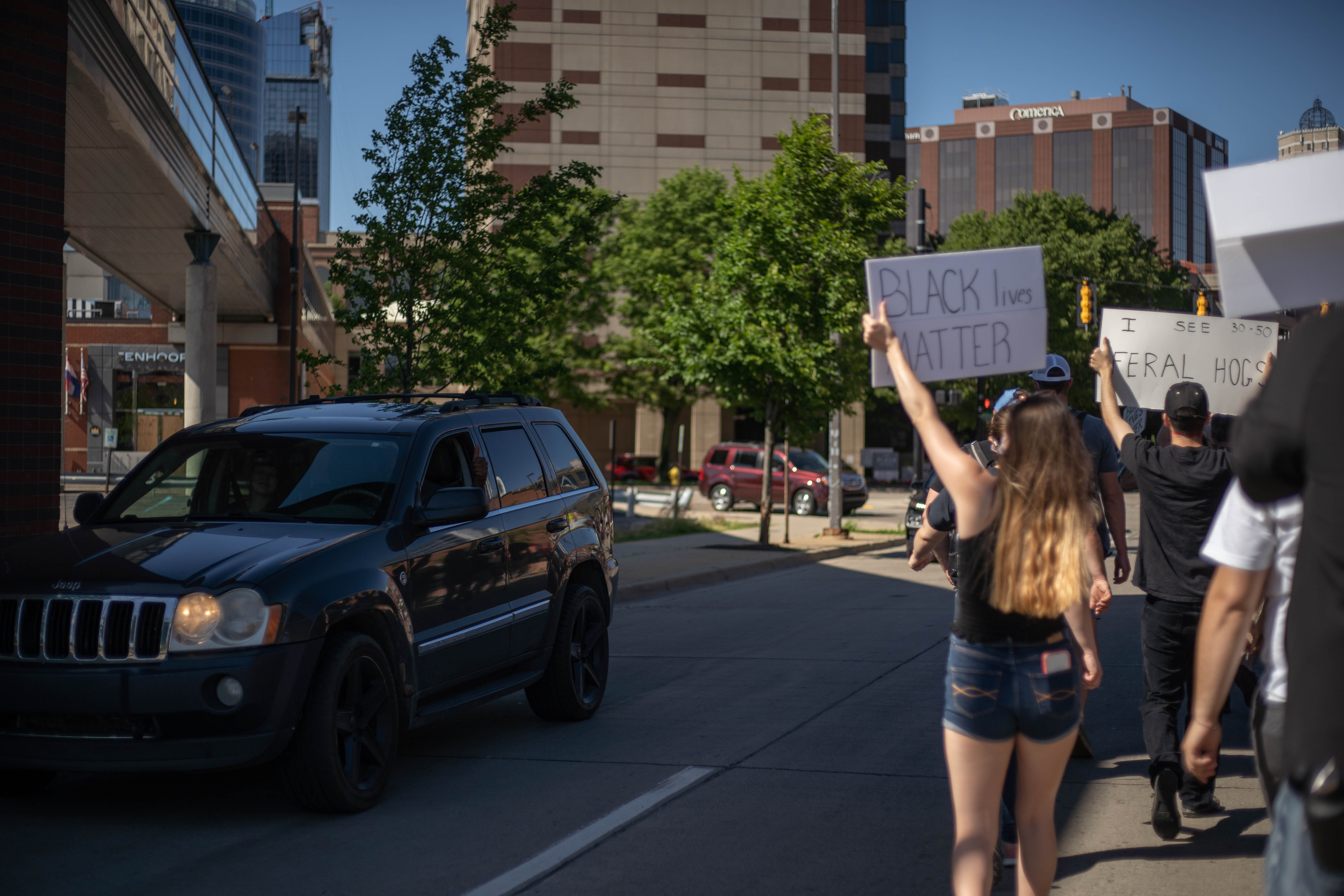 Protesters march against police brutality throughout downtown Grand ...