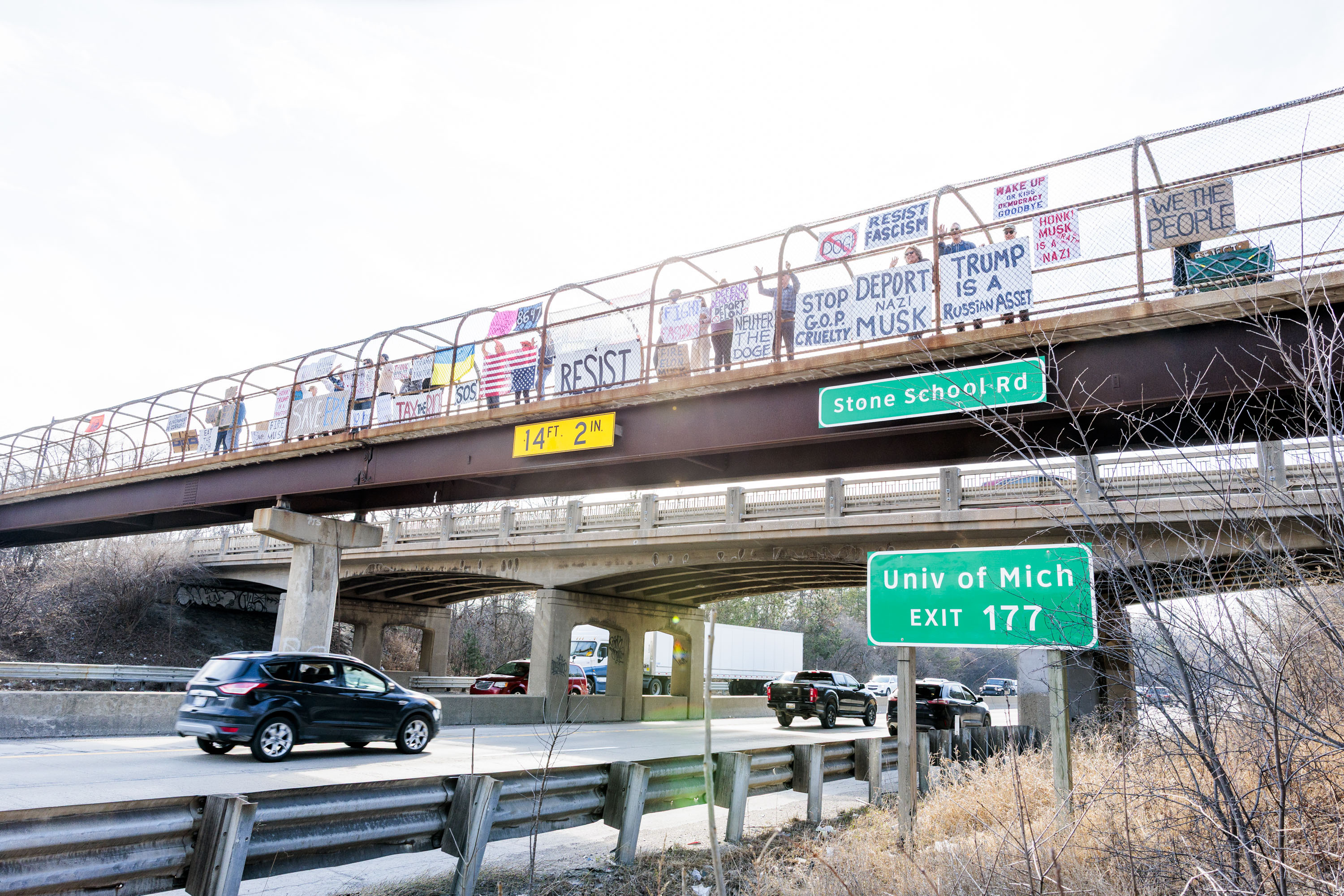 Demonstrators protest Trump Administration on four Ann Arbor pedestrian ...