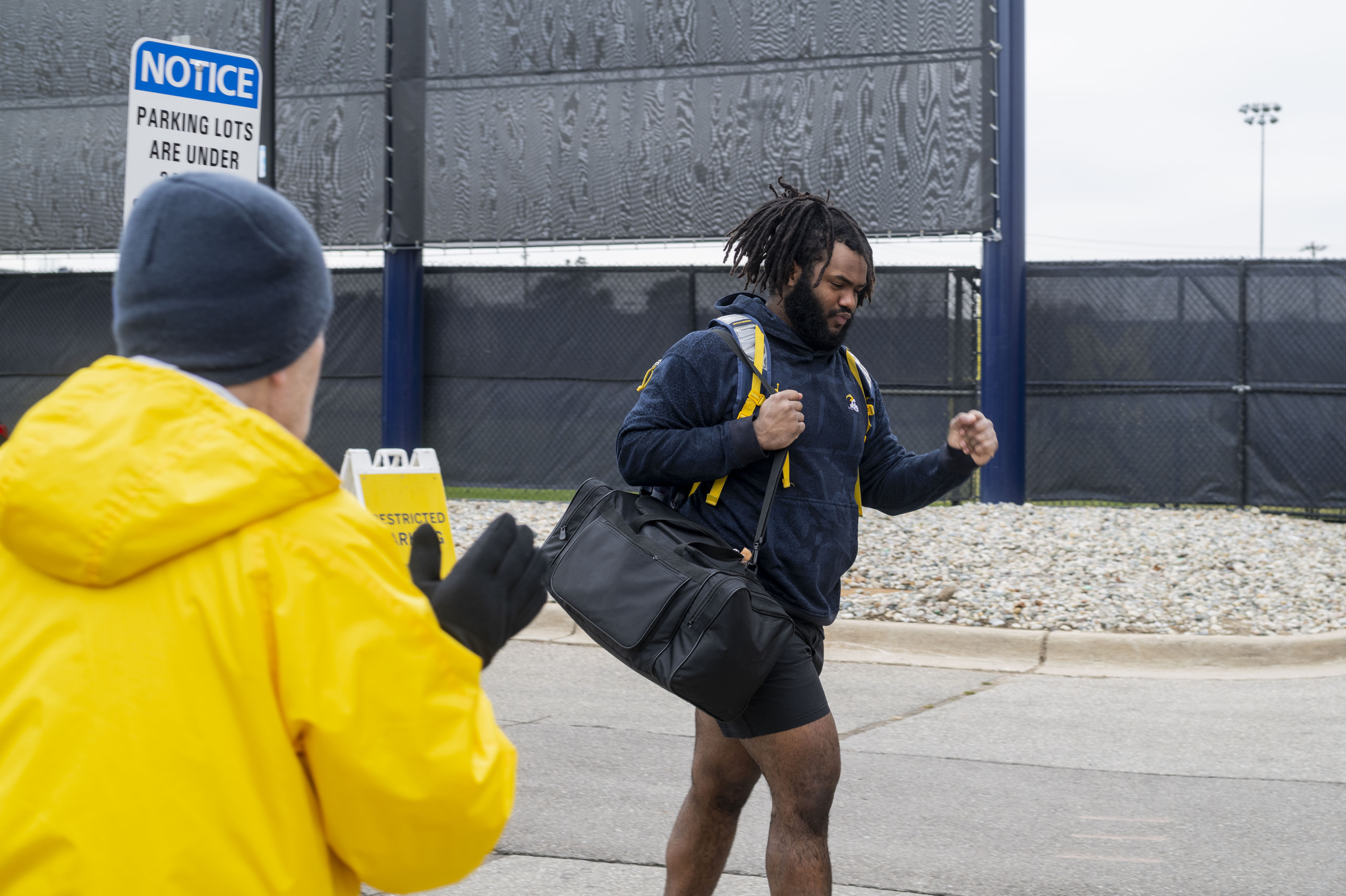 Michigan football players depart Ann Arbor bound for national ...