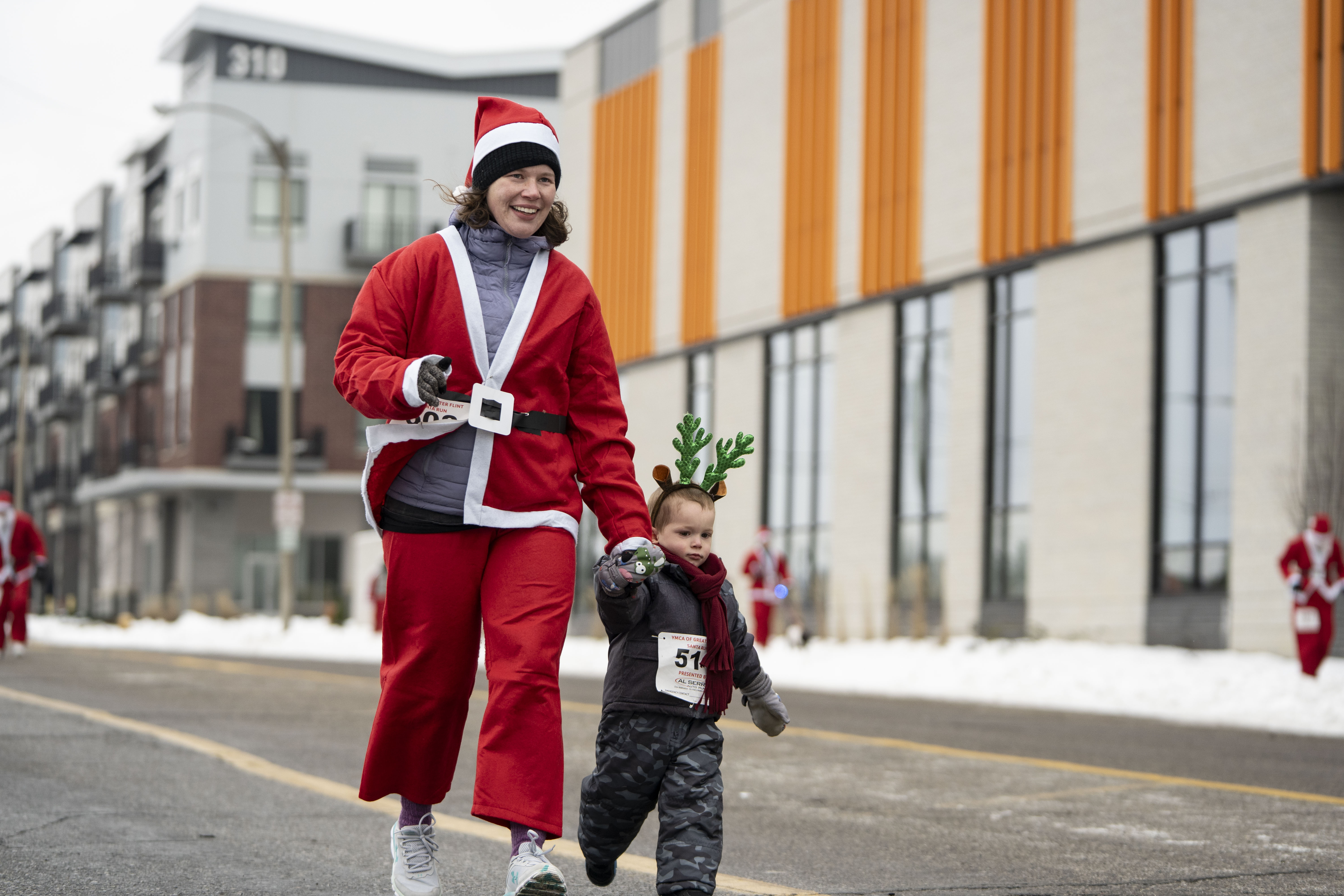 Hundreds put on their red suits for the YMCA Santa Run - mlive.com