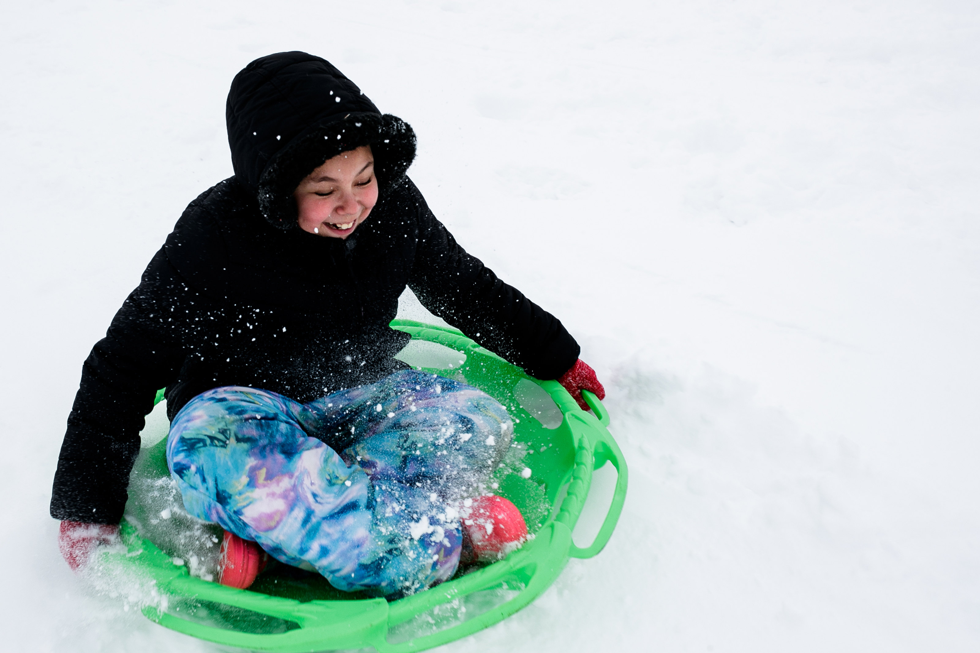 Families enjoy the snow, sledding hill at Flint Southwestern Classical ...