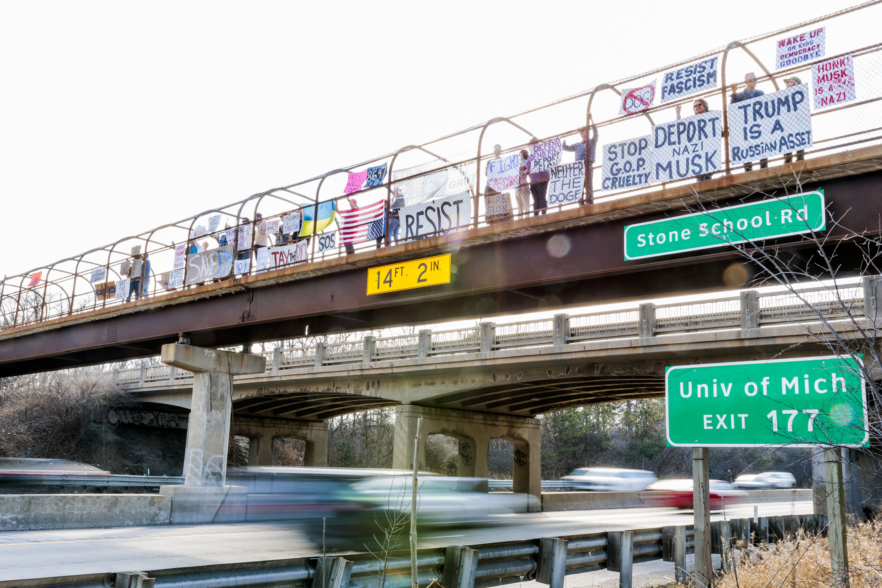 Demonstrators protest Trump Administration on four Ann Arbor pedestrian ...