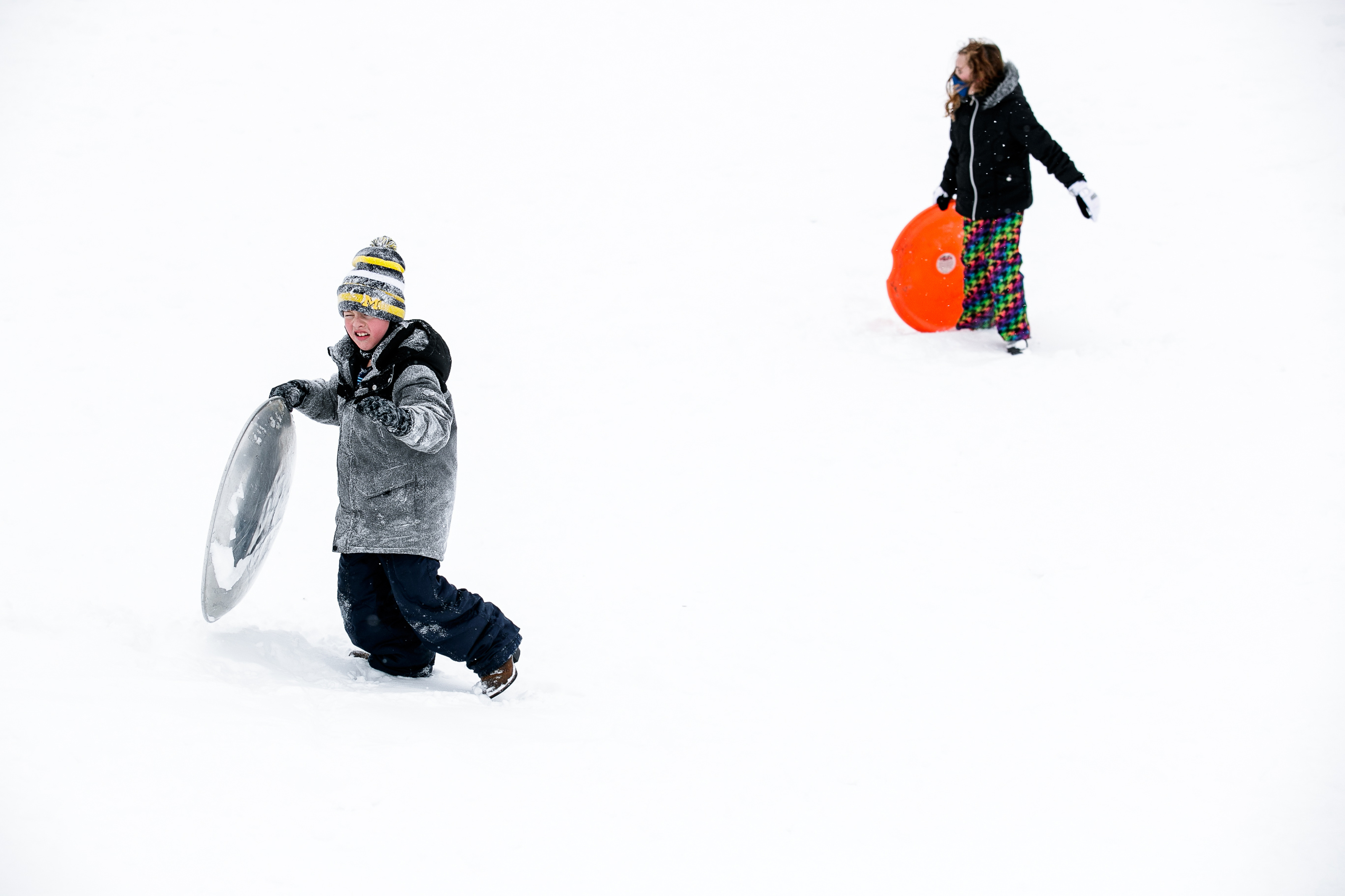 Families enjoy the snow, sledding hill at Flint Southwestern Classical ...