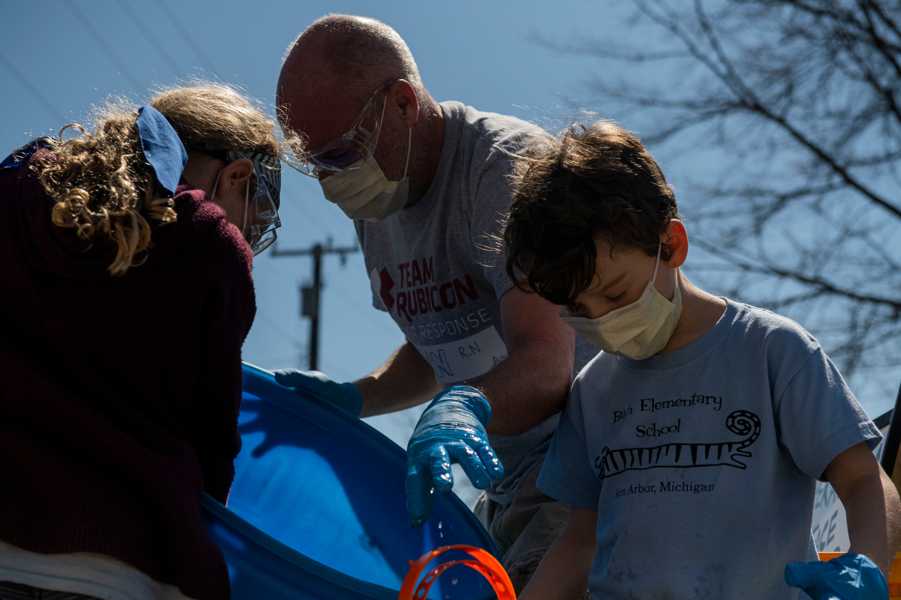 Kevin Leeser and his children prepare shields for healthcare workers ...