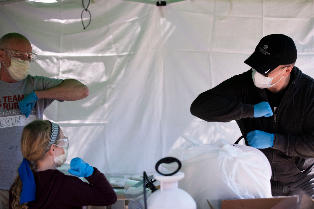 Kevin Leeser and his children prepare shields for healthcare workers ...