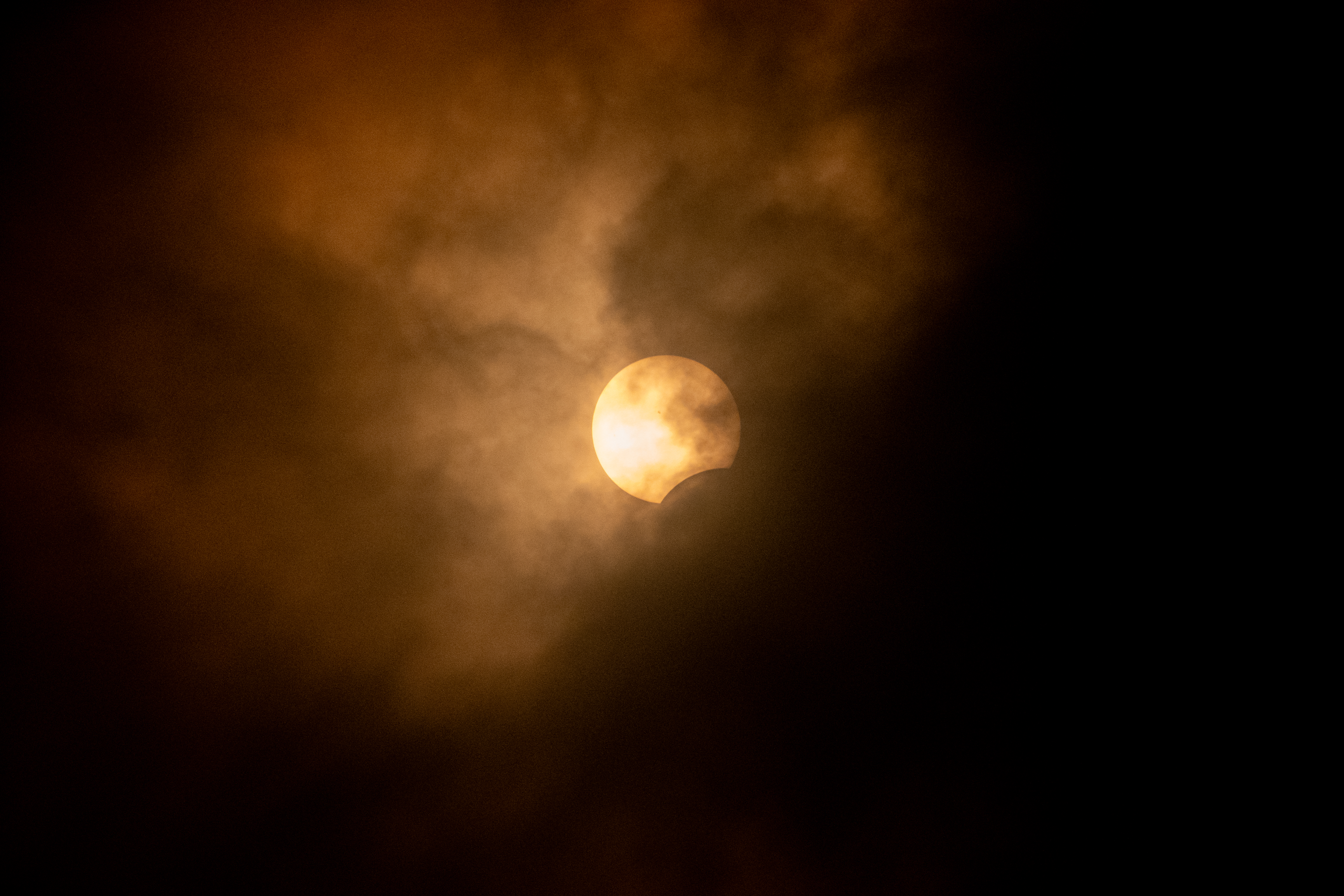 The 2024 solar eclipse seen through the clouds in Southeast Portland ...