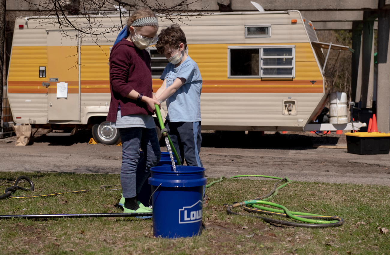 Kevin Leeser and his children prepare shields for healthcare workers ...