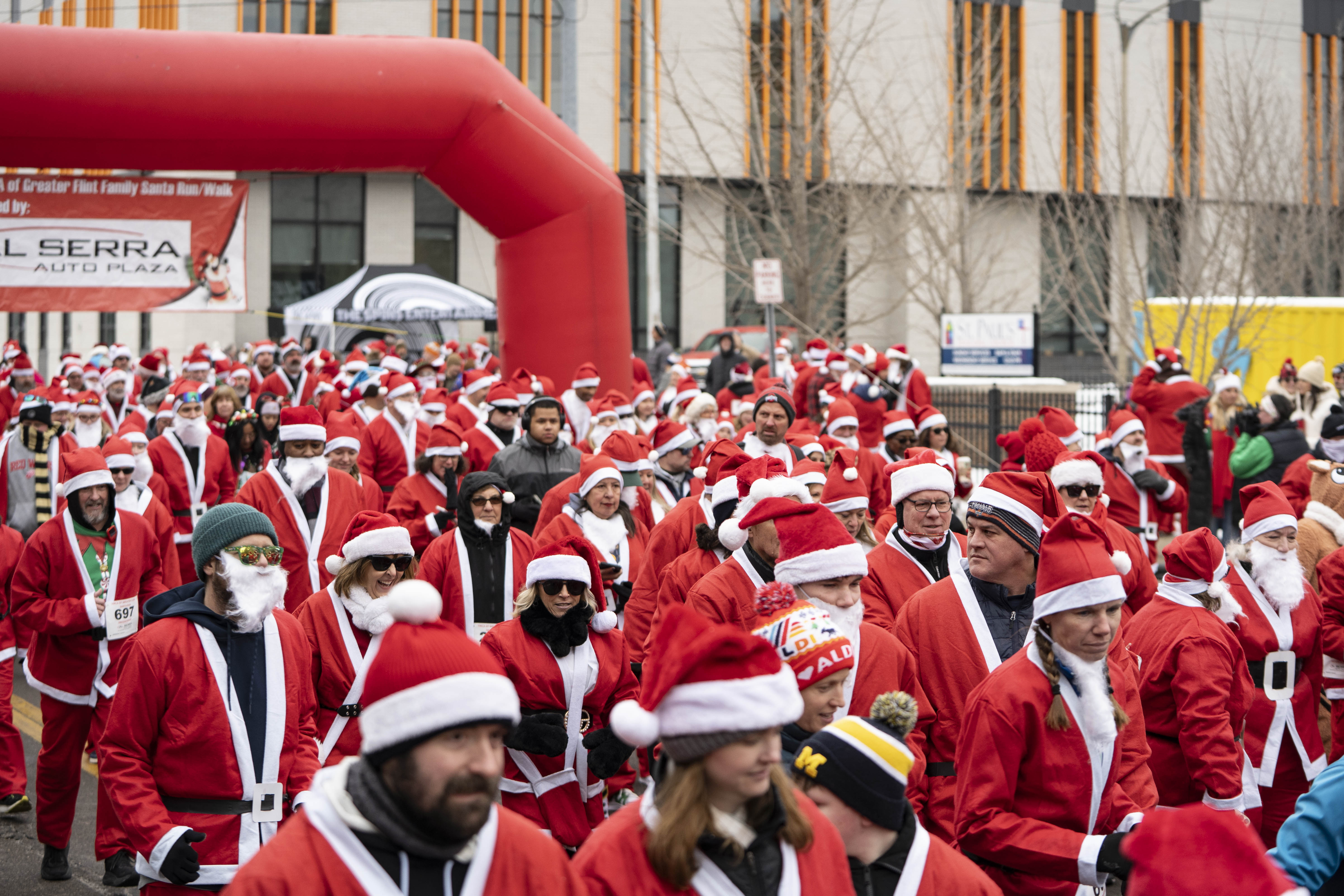 Hundreds put on their red suits for the YMCA Santa Run - mlive.com