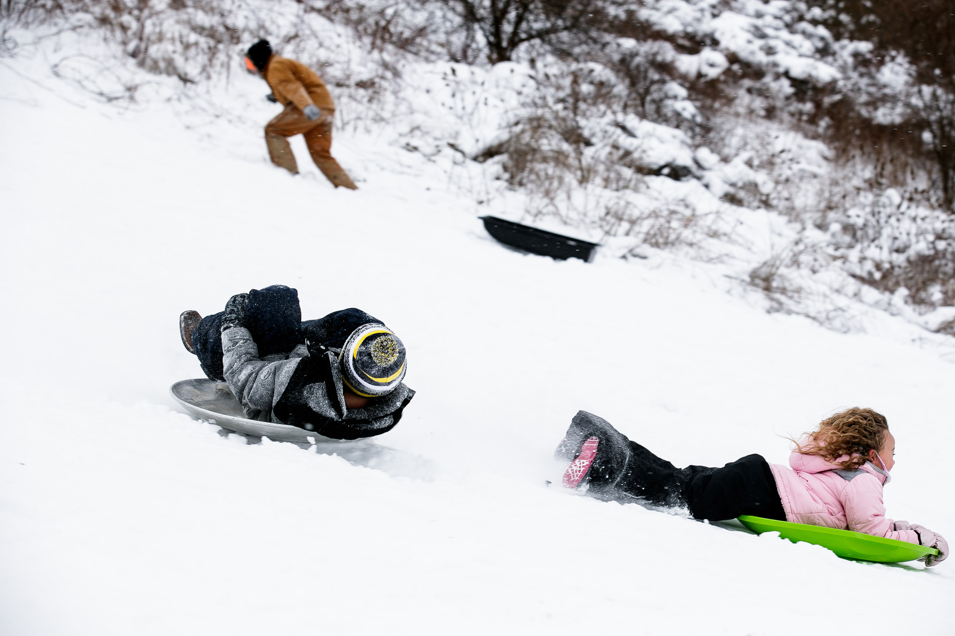 Families enjoy the snow, sledding hill at Flint Southwestern Classical ...