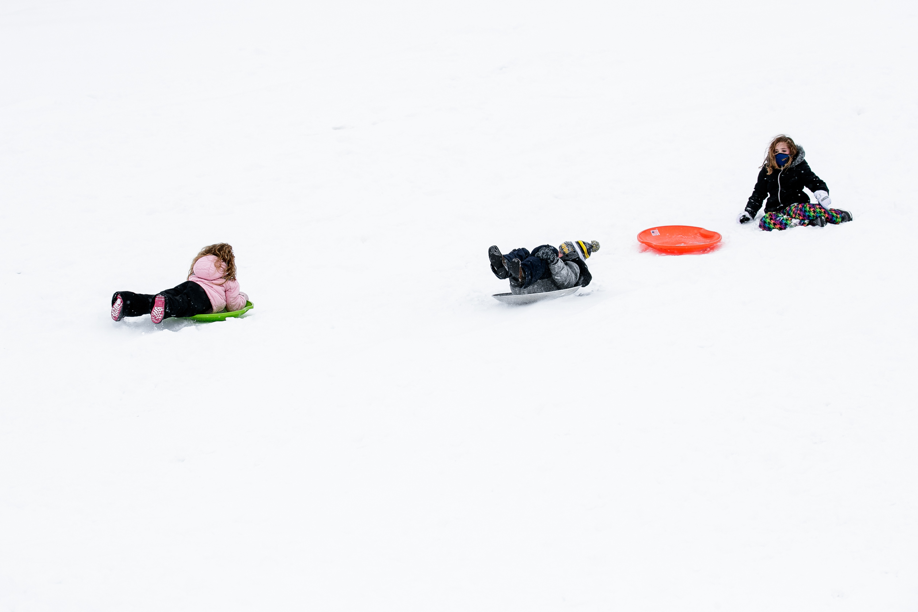 Families enjoy the snow, sledding hill at Flint Southwestern Classical ...