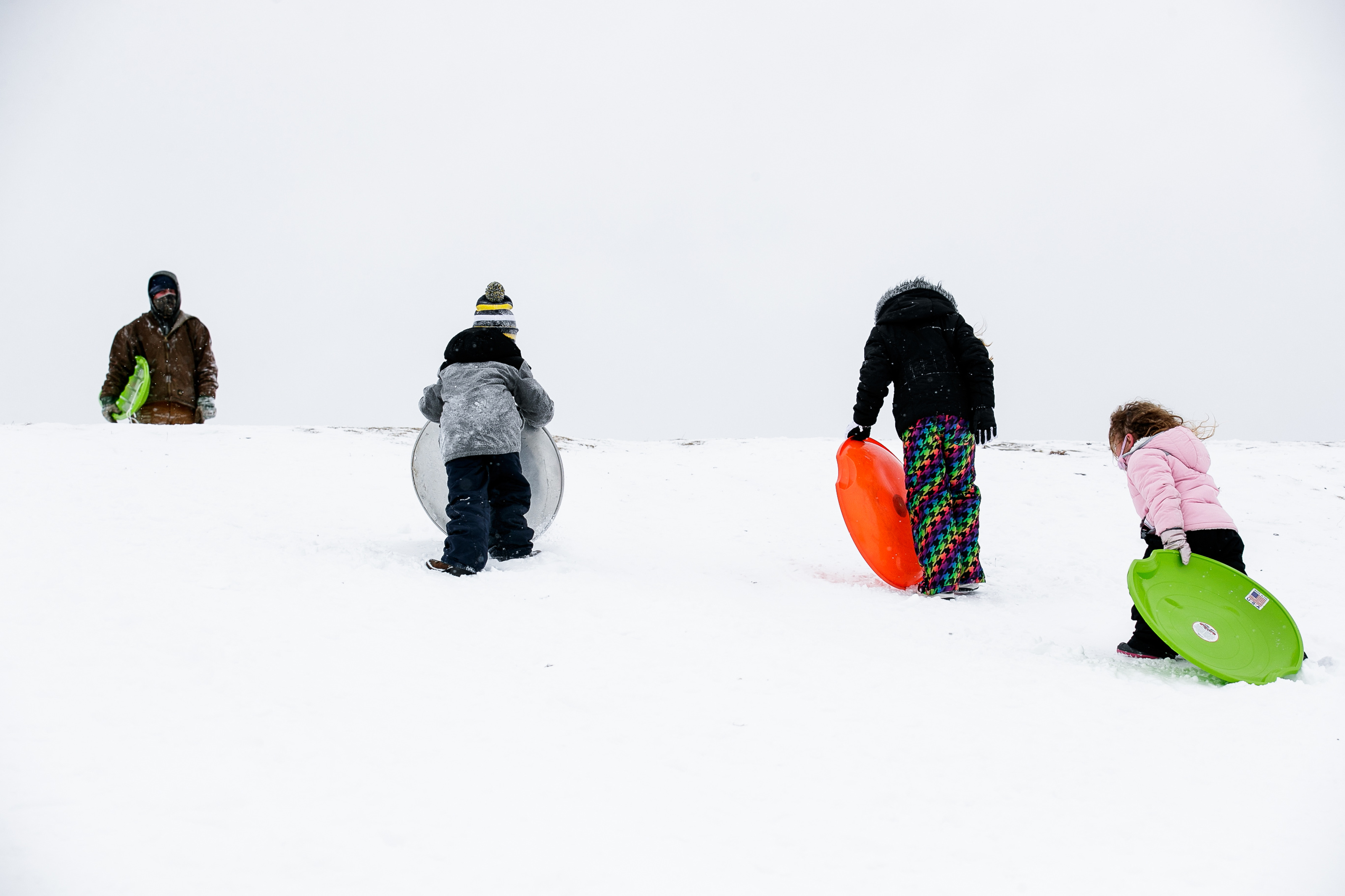 Families enjoy the snow, sledding hill at Flint Southwestern Classical ...