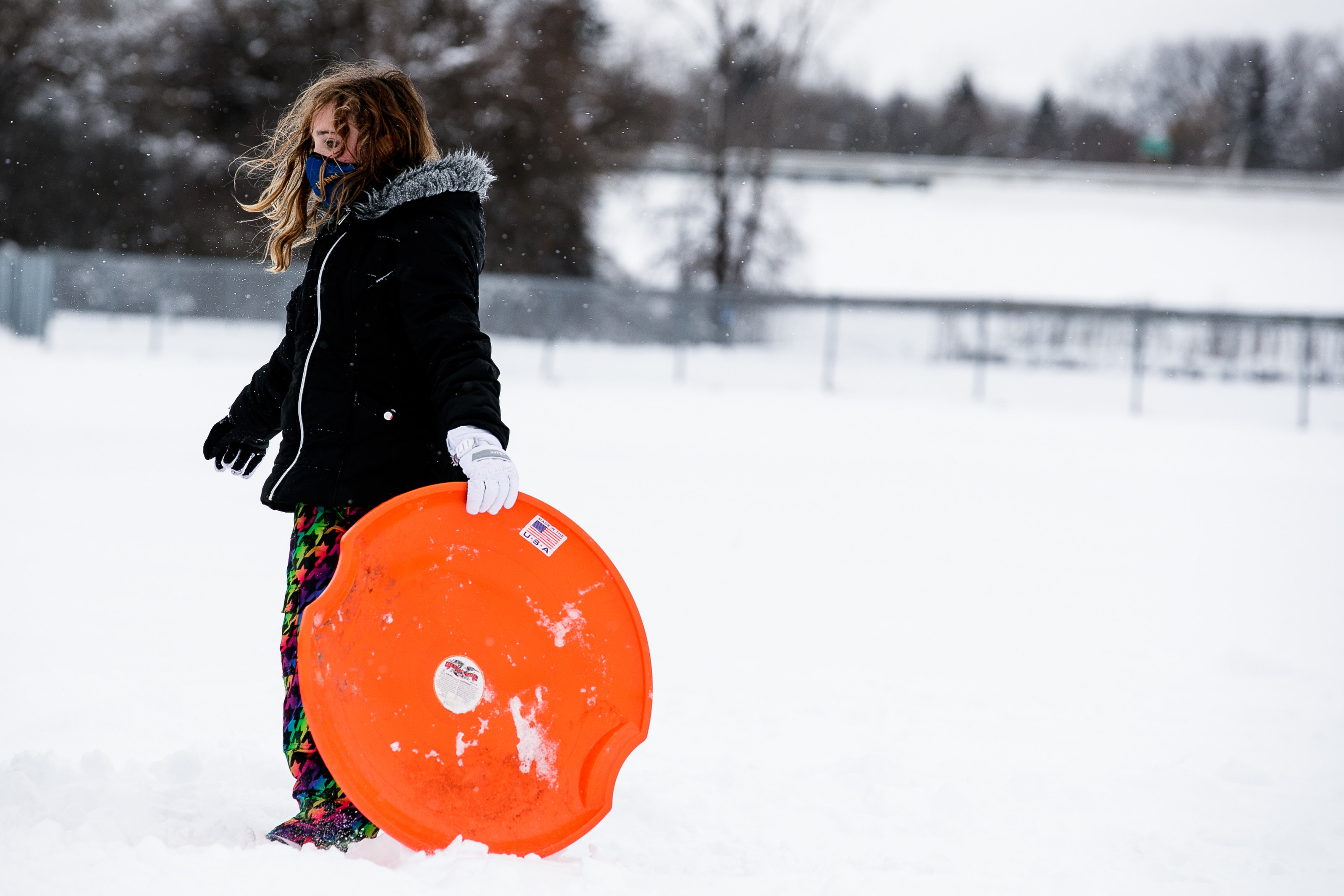 Families enjoy the snow, sledding hill at Flint Southwestern Classical ...