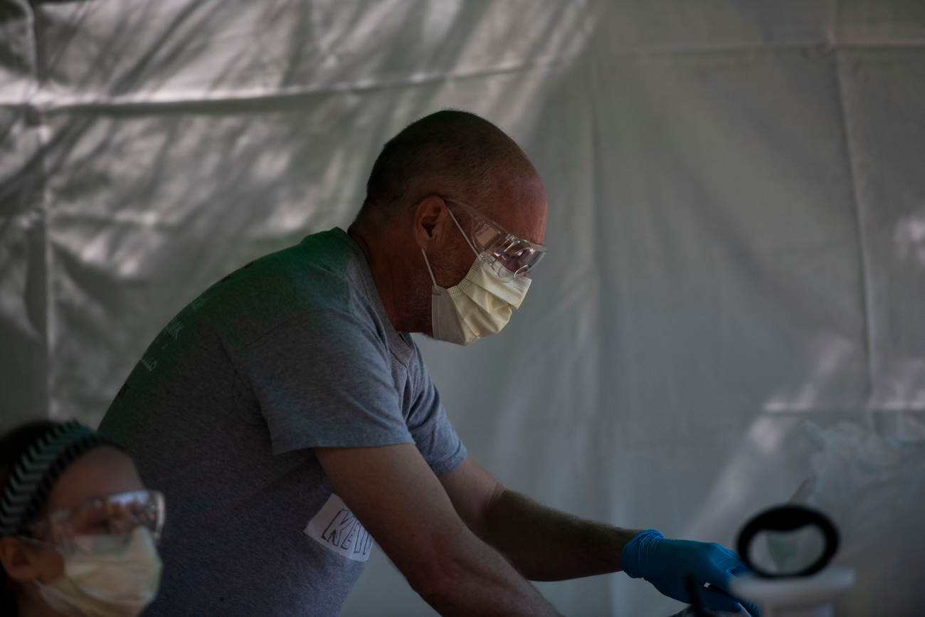 Kevin Leeser and his children prepare shields for healthcare workers ...