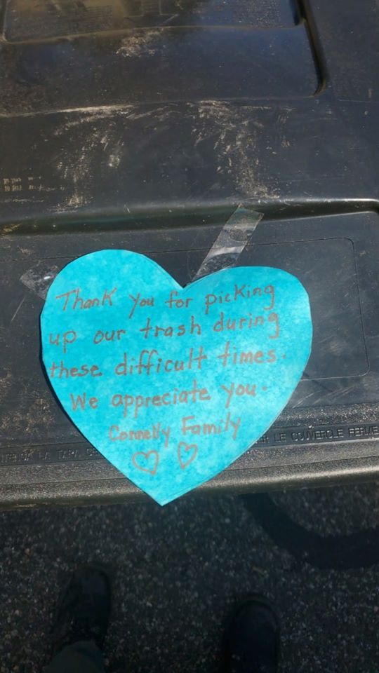 Thank you signs decorate trash cans for worker helping others run ...
