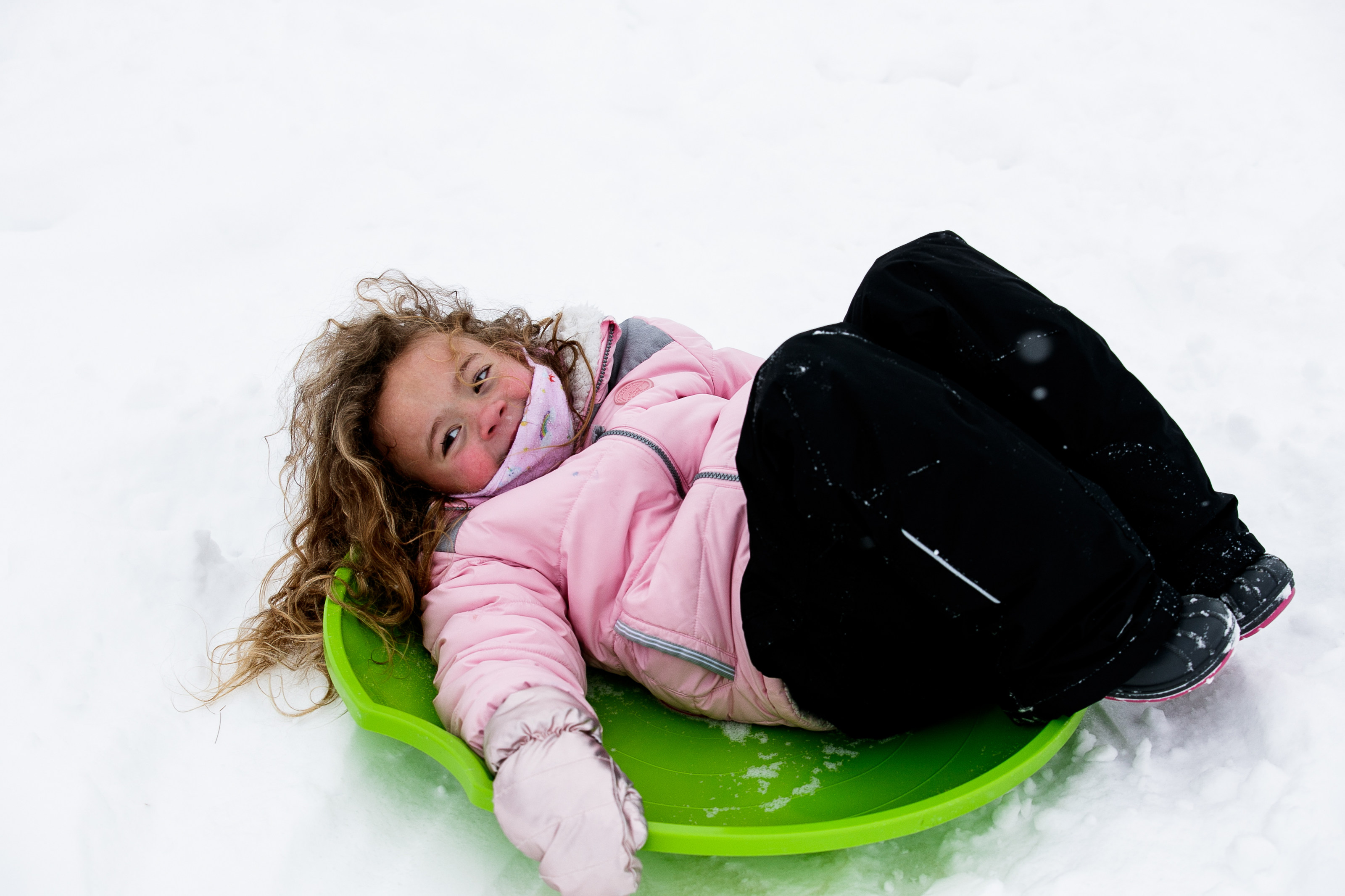 Families enjoy the snow, sledding hill at Flint Southwestern Classical ...