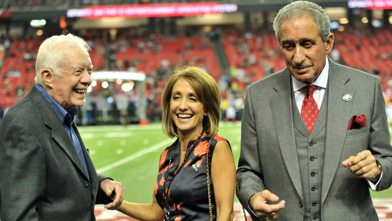 Who is Angela Macuga, wife of Atlanta Falcons owner Arthur Blank?