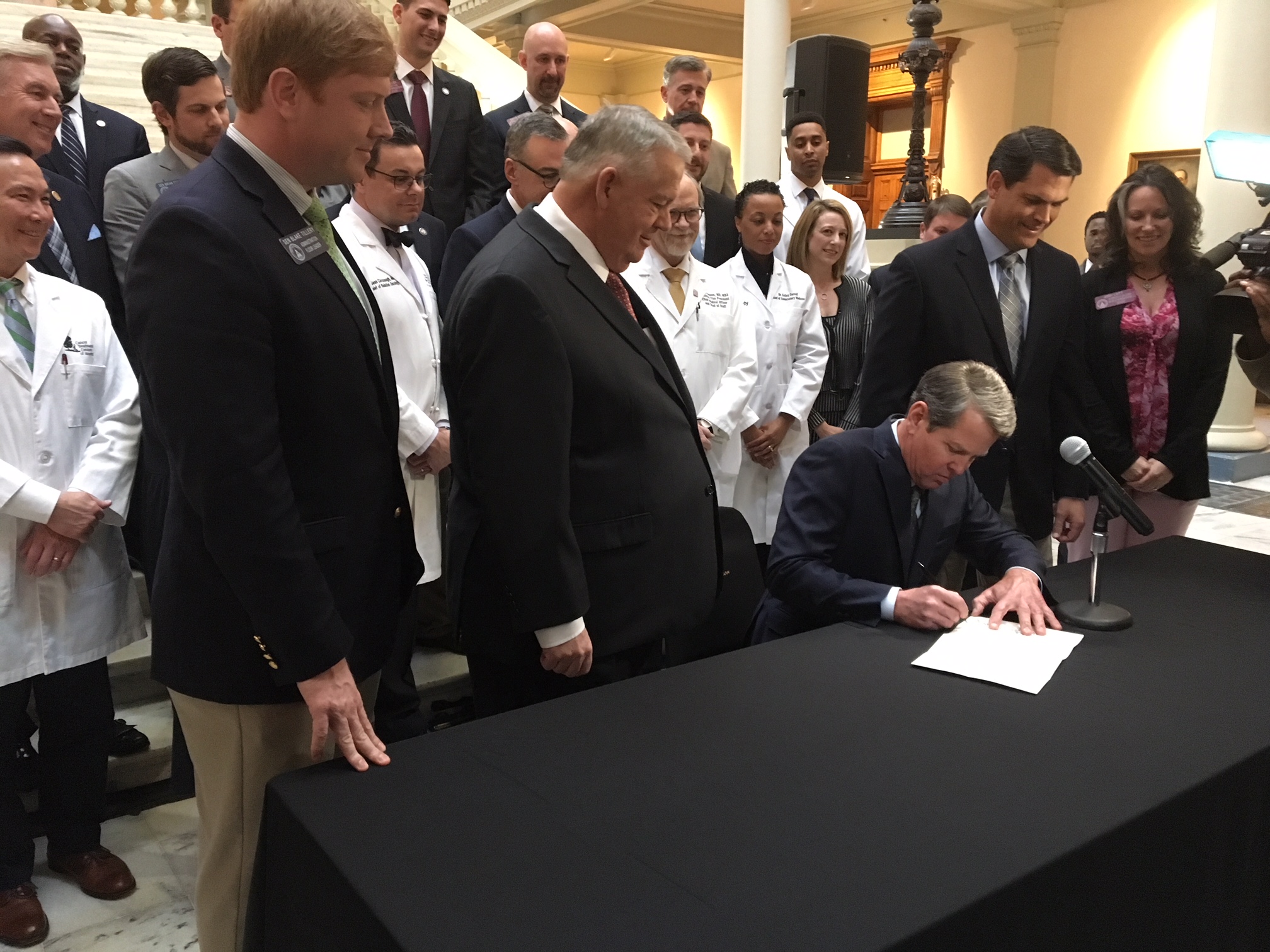 Gov. Brian Kemp signs a bill into law aimed at expanding healthcare in ...