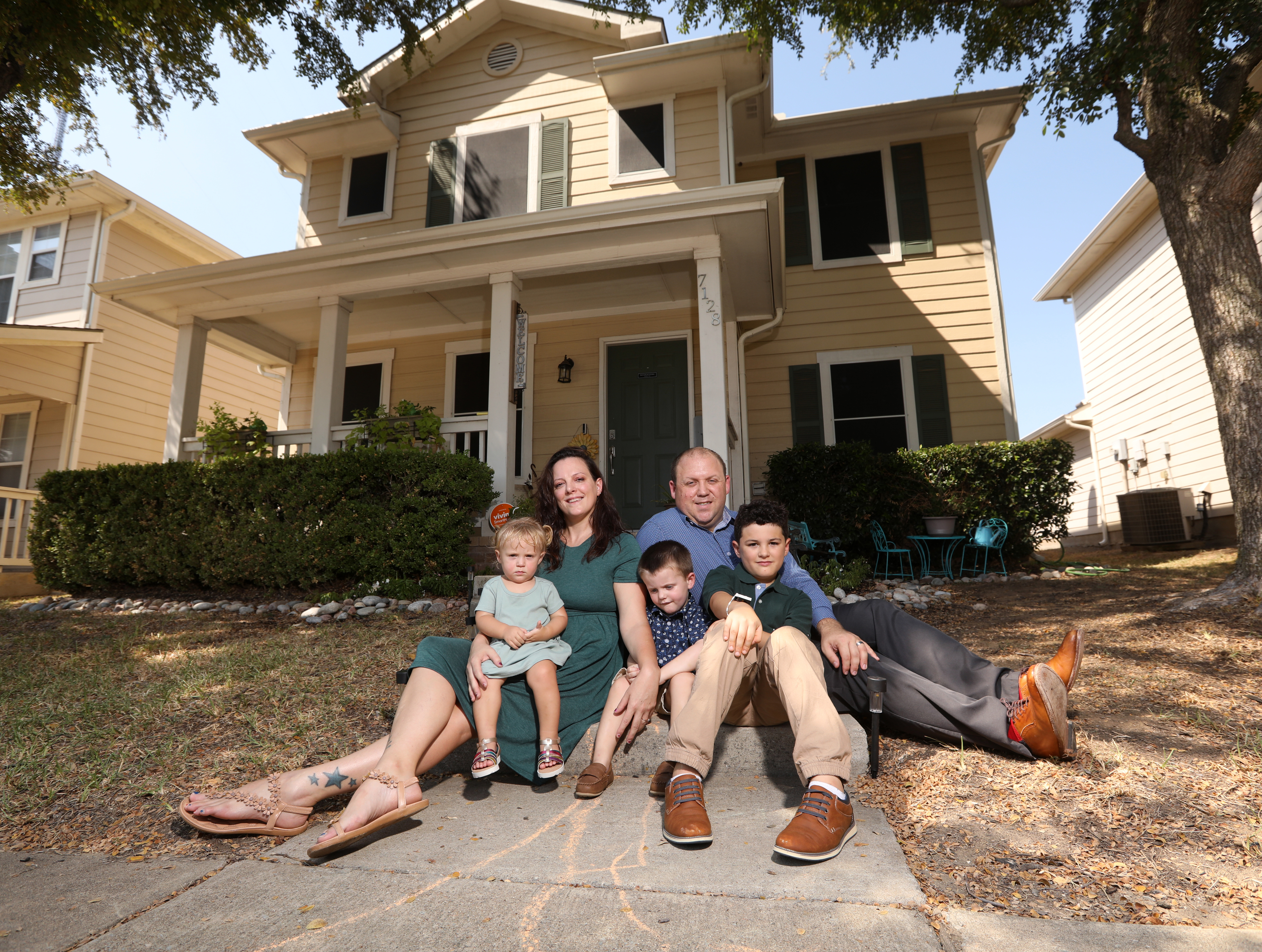 Family In Front Of Home