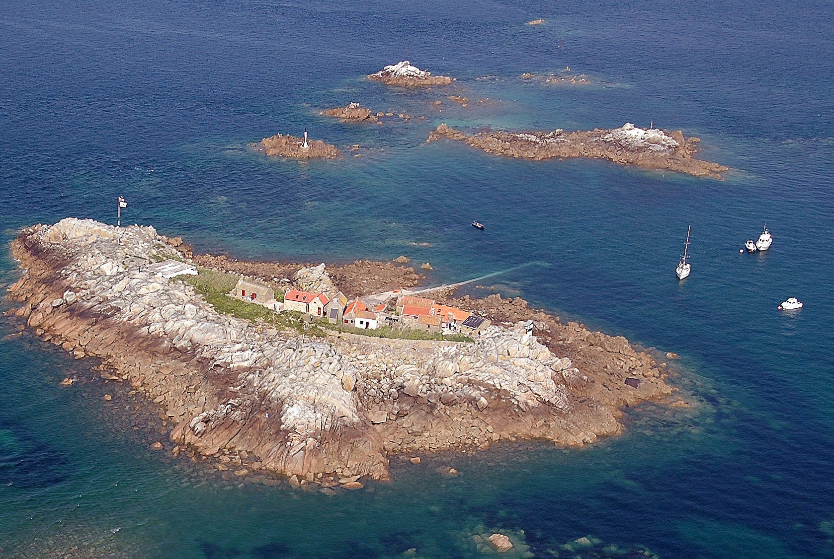 WATCH: Three rescued from Minquiers reef after boat sinks - Jersey ...