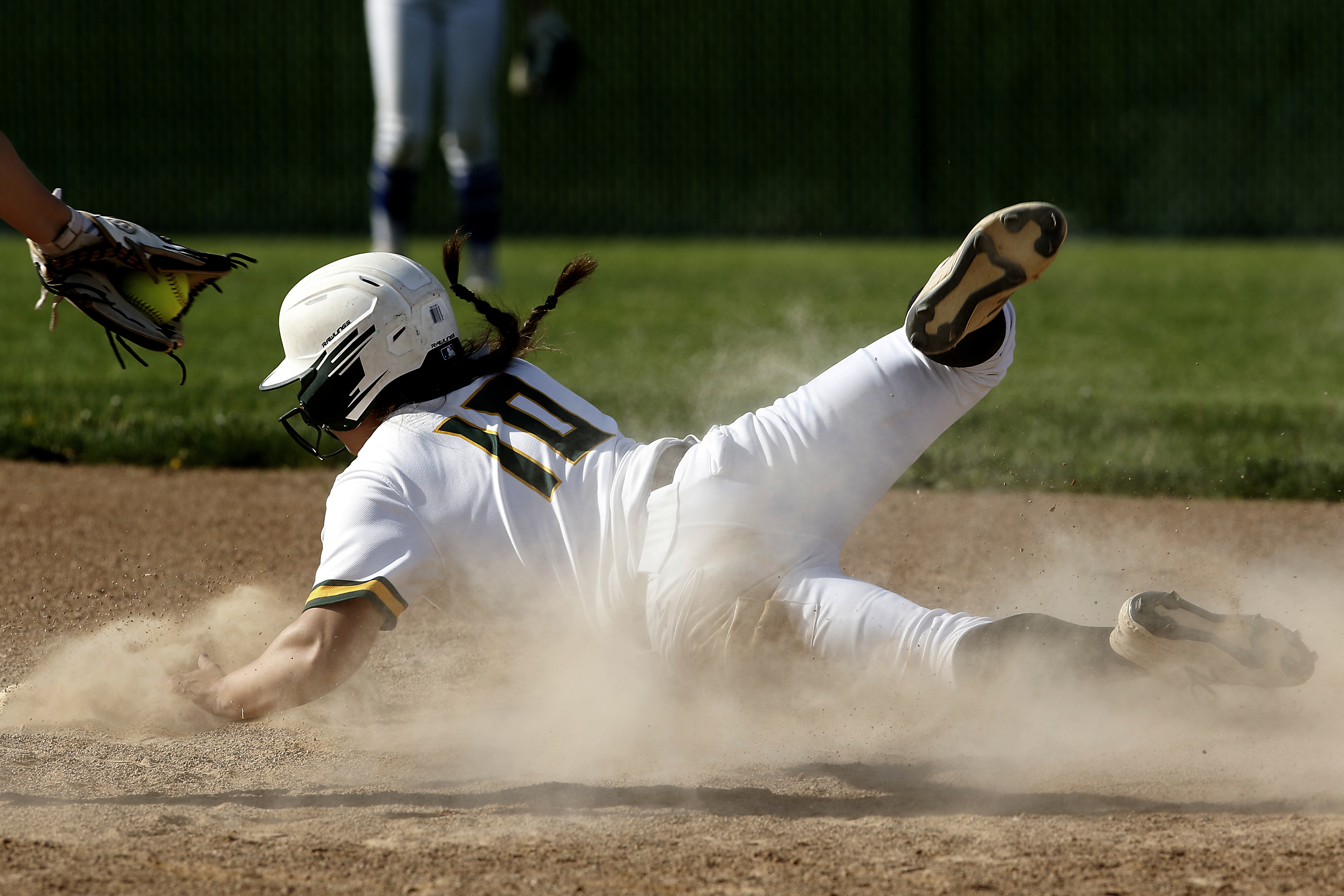 Softball Players Sliding