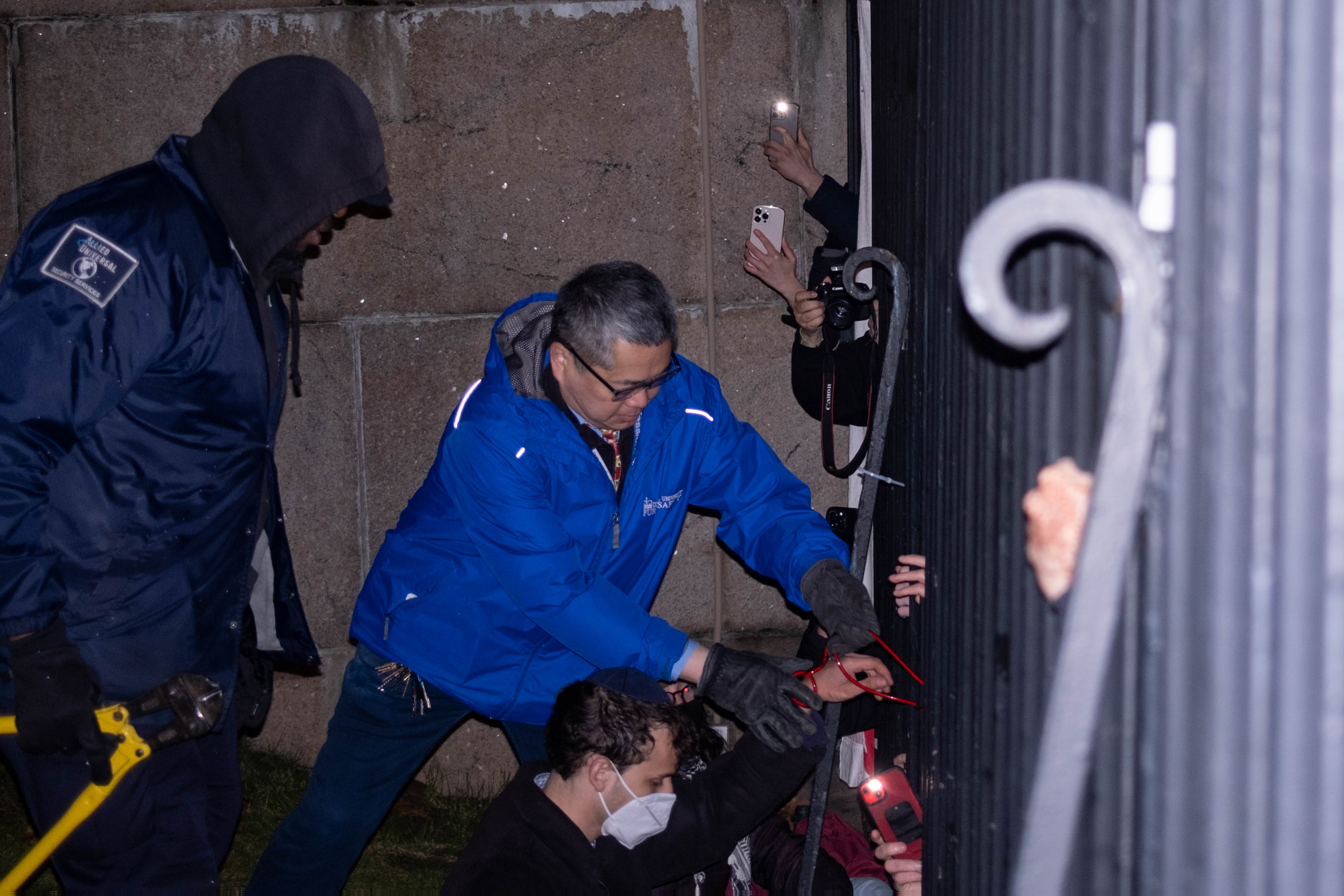 Public Safety officers cut off bike locks tethering protesters to gates ...