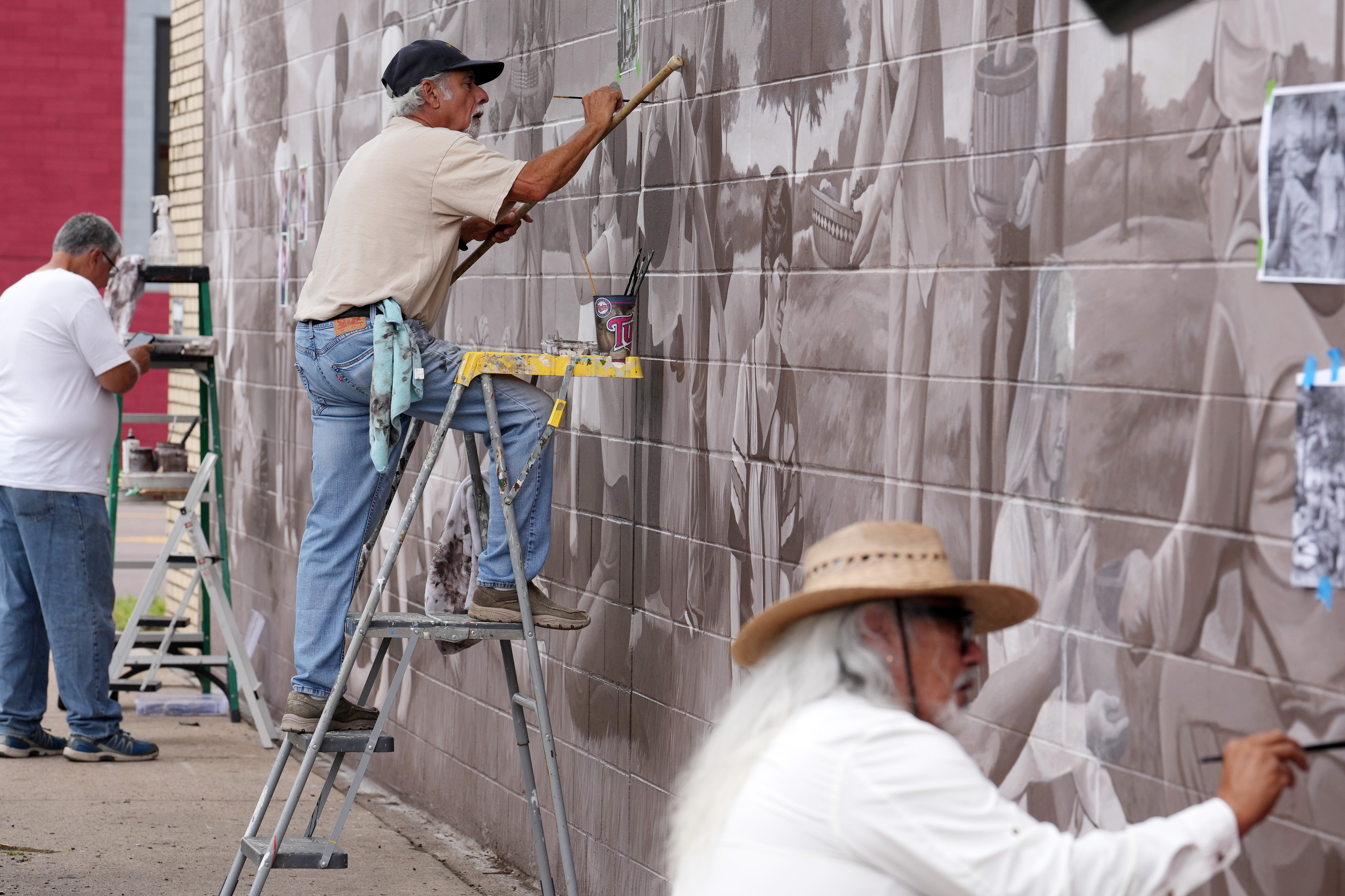 Trio of artists gathers 39 years later to restore West Side mural in St ...
